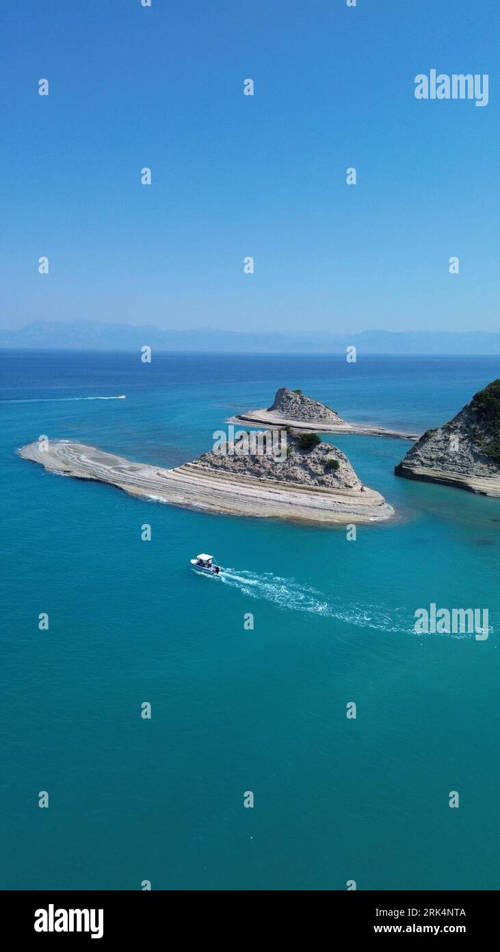An aerial view of the rocky shoreline of Corfu, Greece with its crystal ...