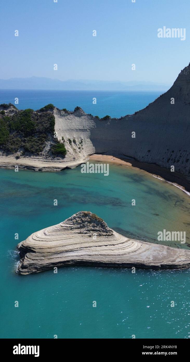 An aerial view of the rocky shoreline of Corfu, Greece with its crystal ...