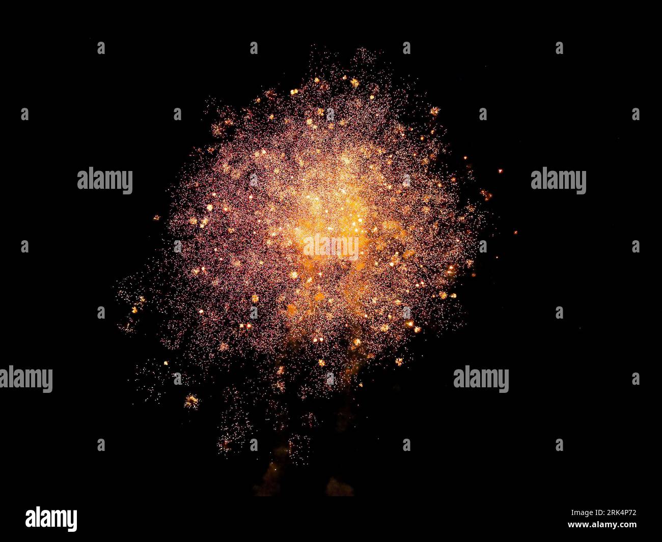 A colorful display of fireworks explodes in the night sky, with some ...