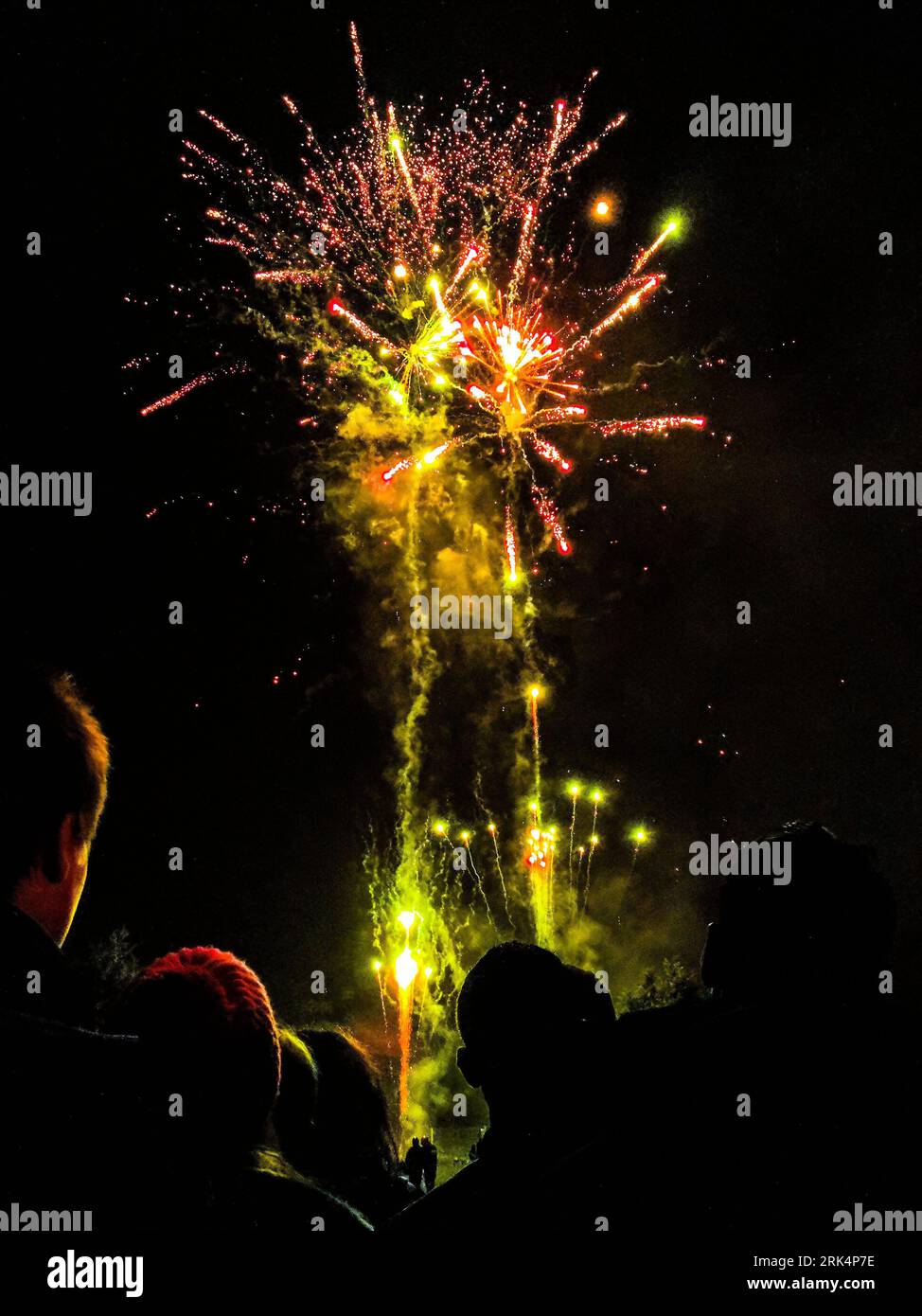 A large crowd of diverse people enjoying a spectacular fireworks ...