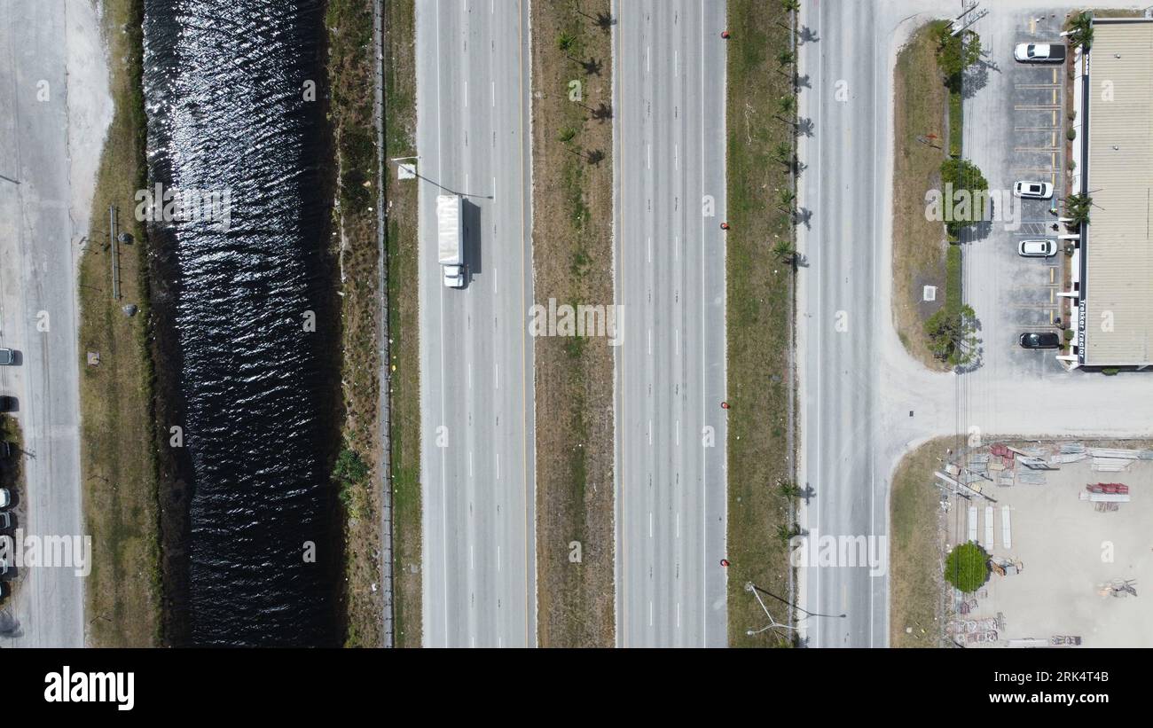 An aerial view of a highway with small buildings and vehicles Stock ...
