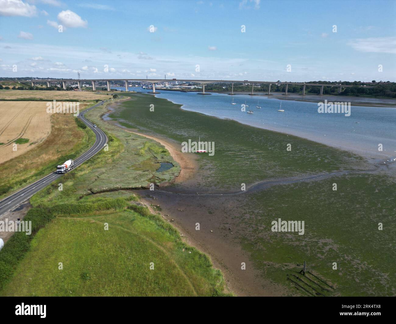 Aerial view of a railway bridge crossing a lush grassy landscape with ...