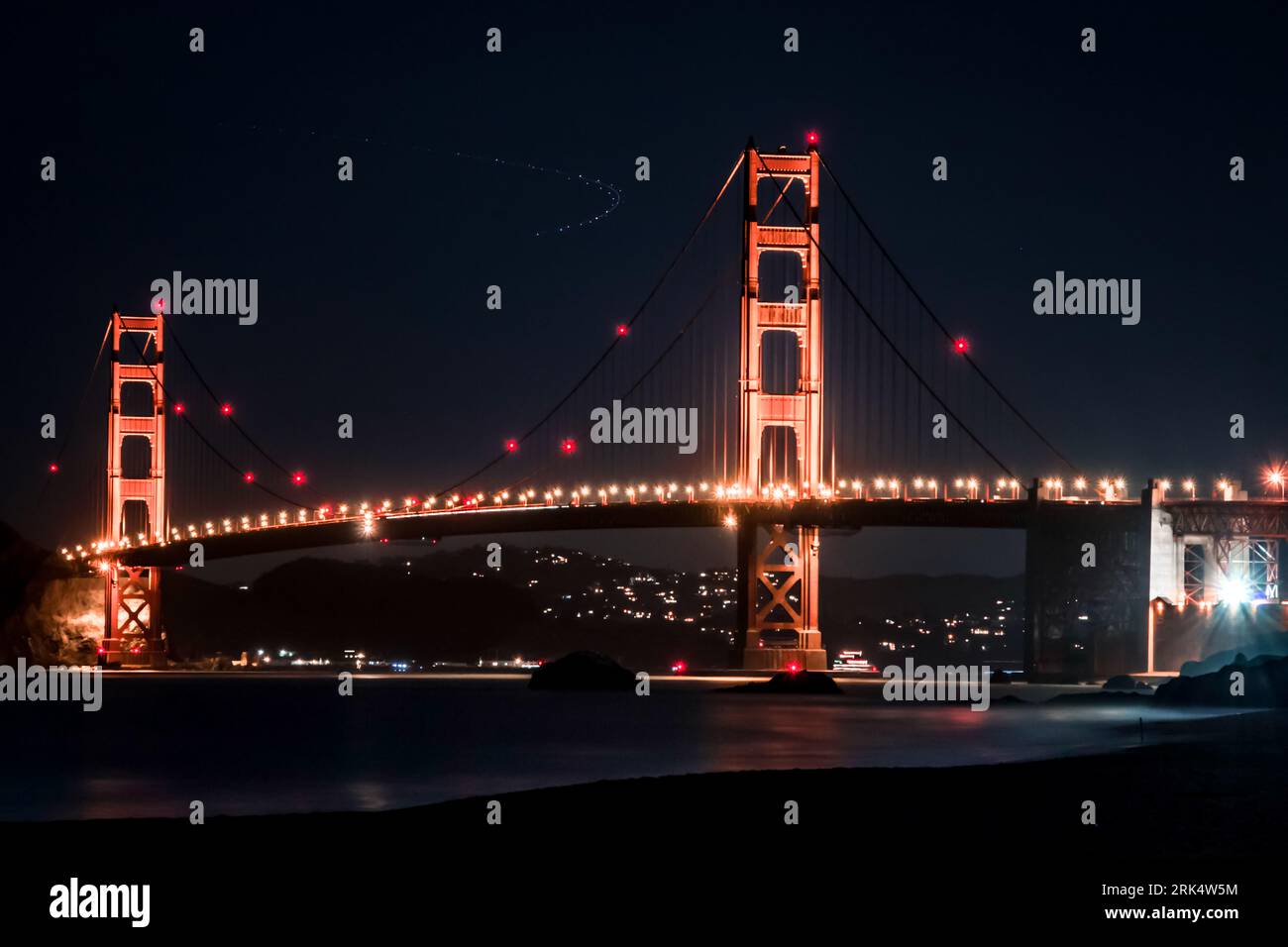 The iconic Golden Gate Bridge is illuminated by bright lights, creating ...