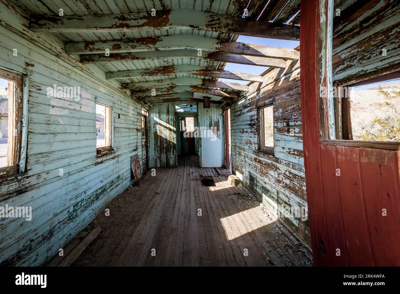 A vintage-style hallway featuring a long, wooden corridor with several ...
