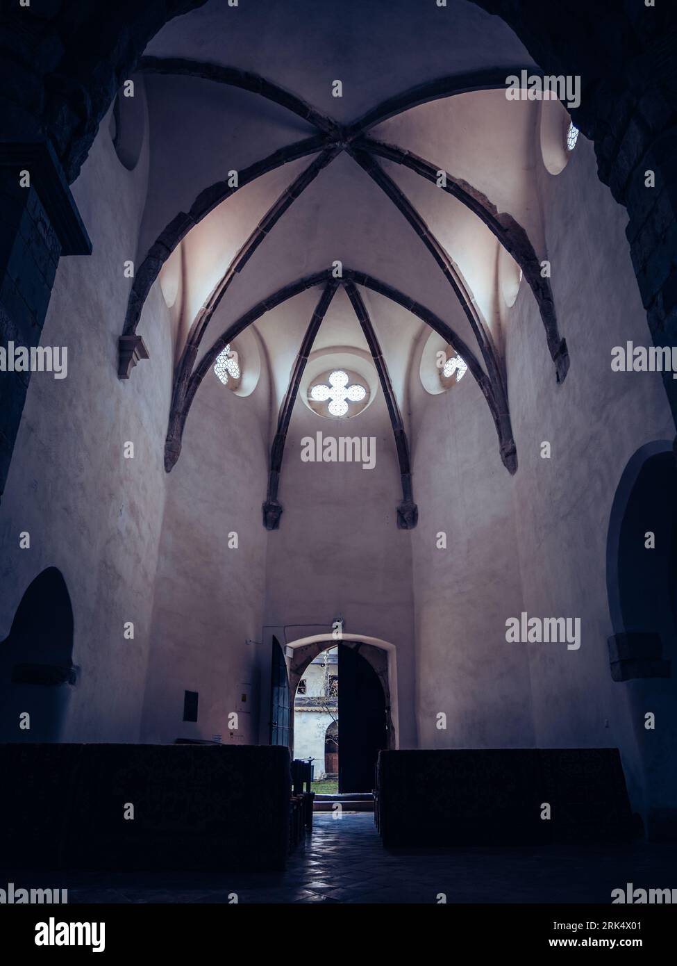 A high ceiling in a large commercial building featuring an abundance of ...