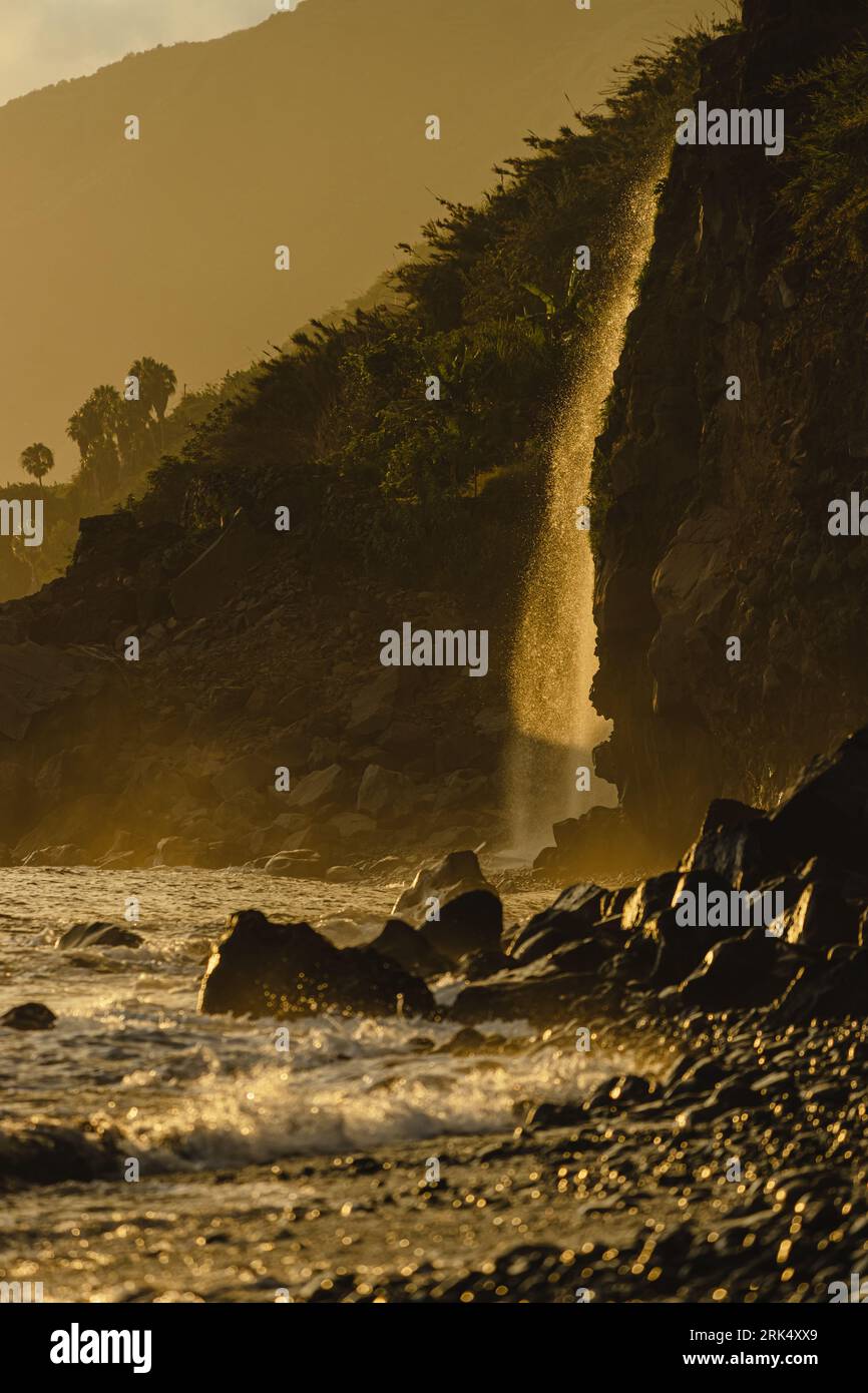 A picturesque landscape featuring a waterfall cascading from a cliff ...