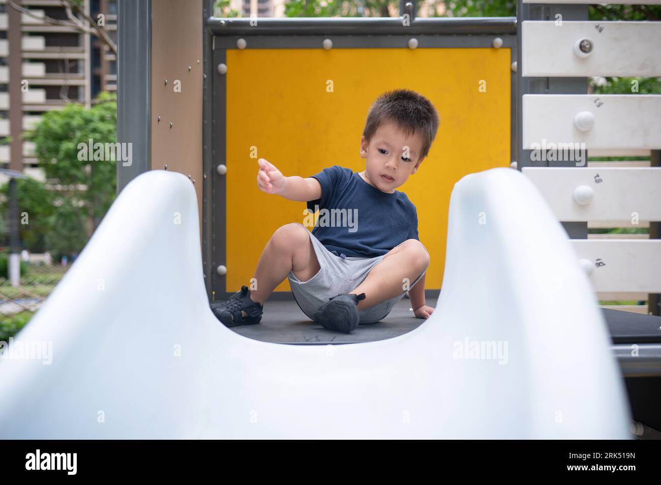 A curious two year old baby boy enjoys discovering the game on the ...