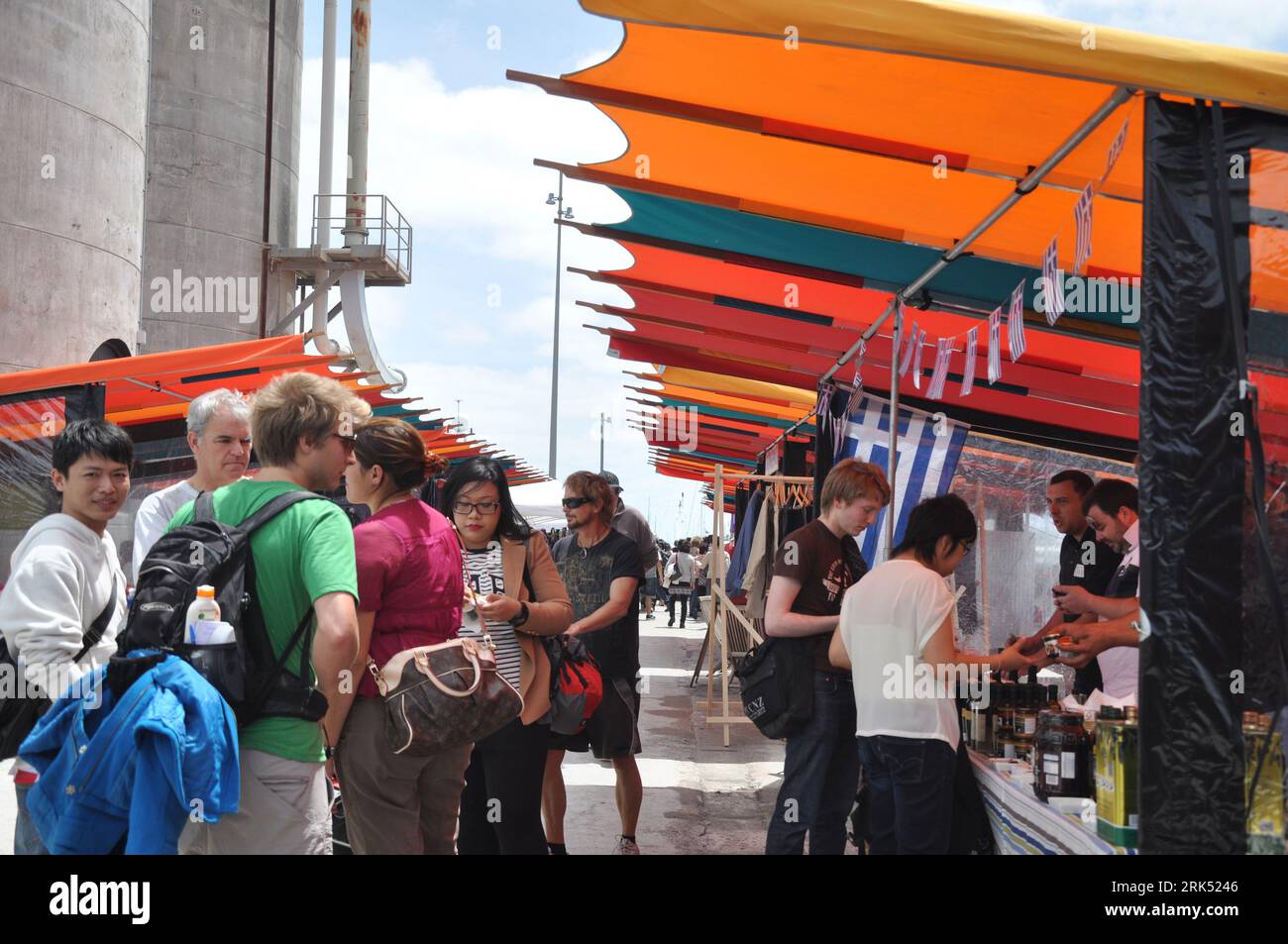 A diverse group of people enjoying the sunny Saturday at the market in ...
