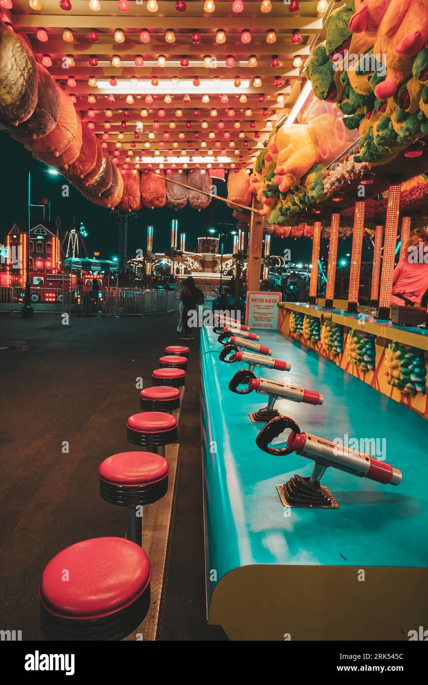 An interior view of an amusement arcade with numerous stools and ...