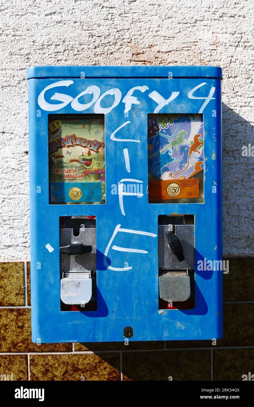 A blue vending machine with colorful depictions of mobile phones ...