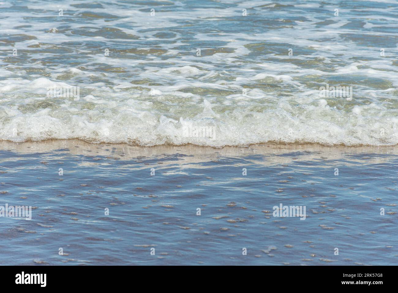 A Top view of the foam of a wave arriving at the seashore Stock Photo ...