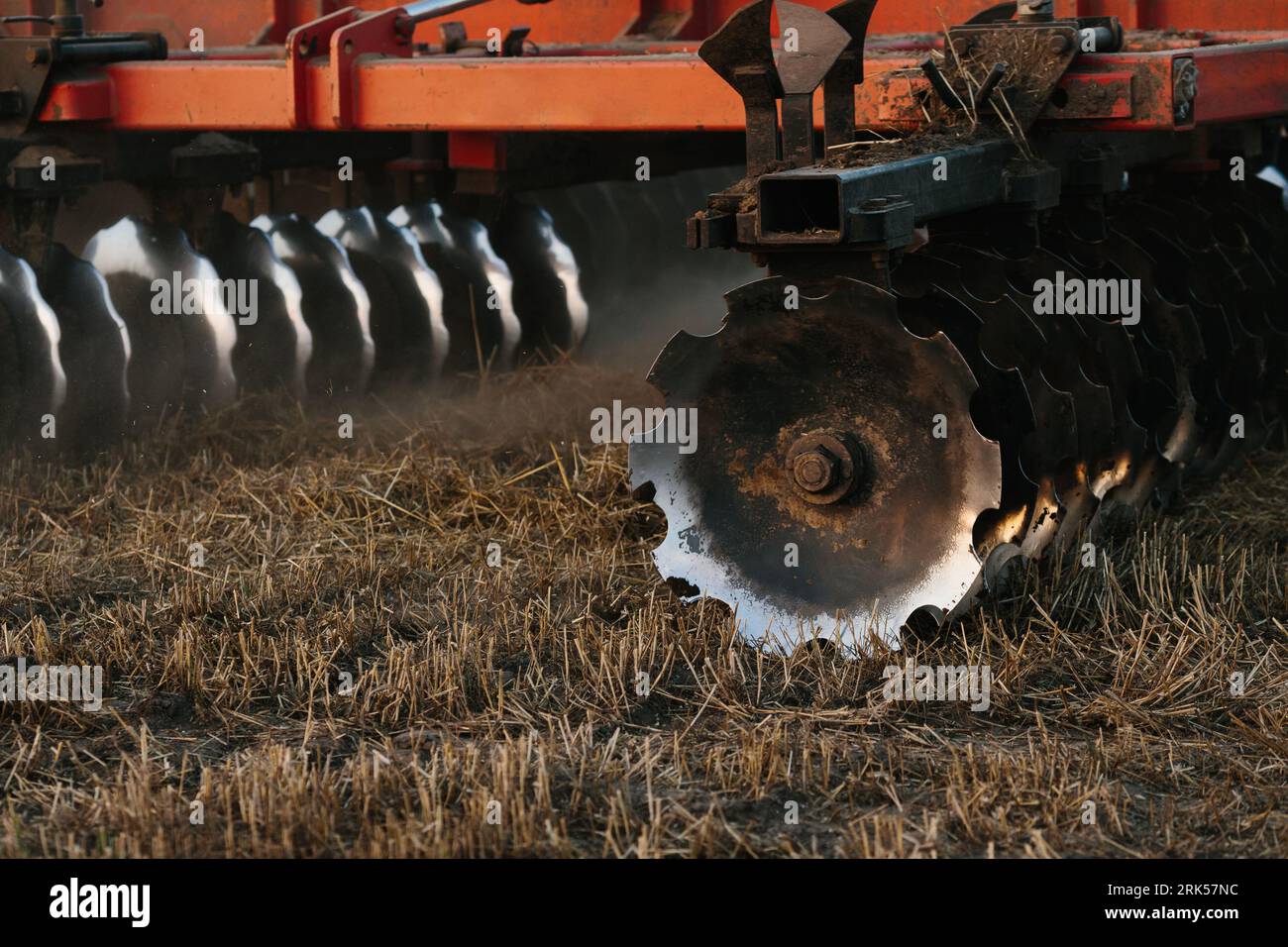 A tractor with a large disc harrow for tillage. Farmer work concept ...