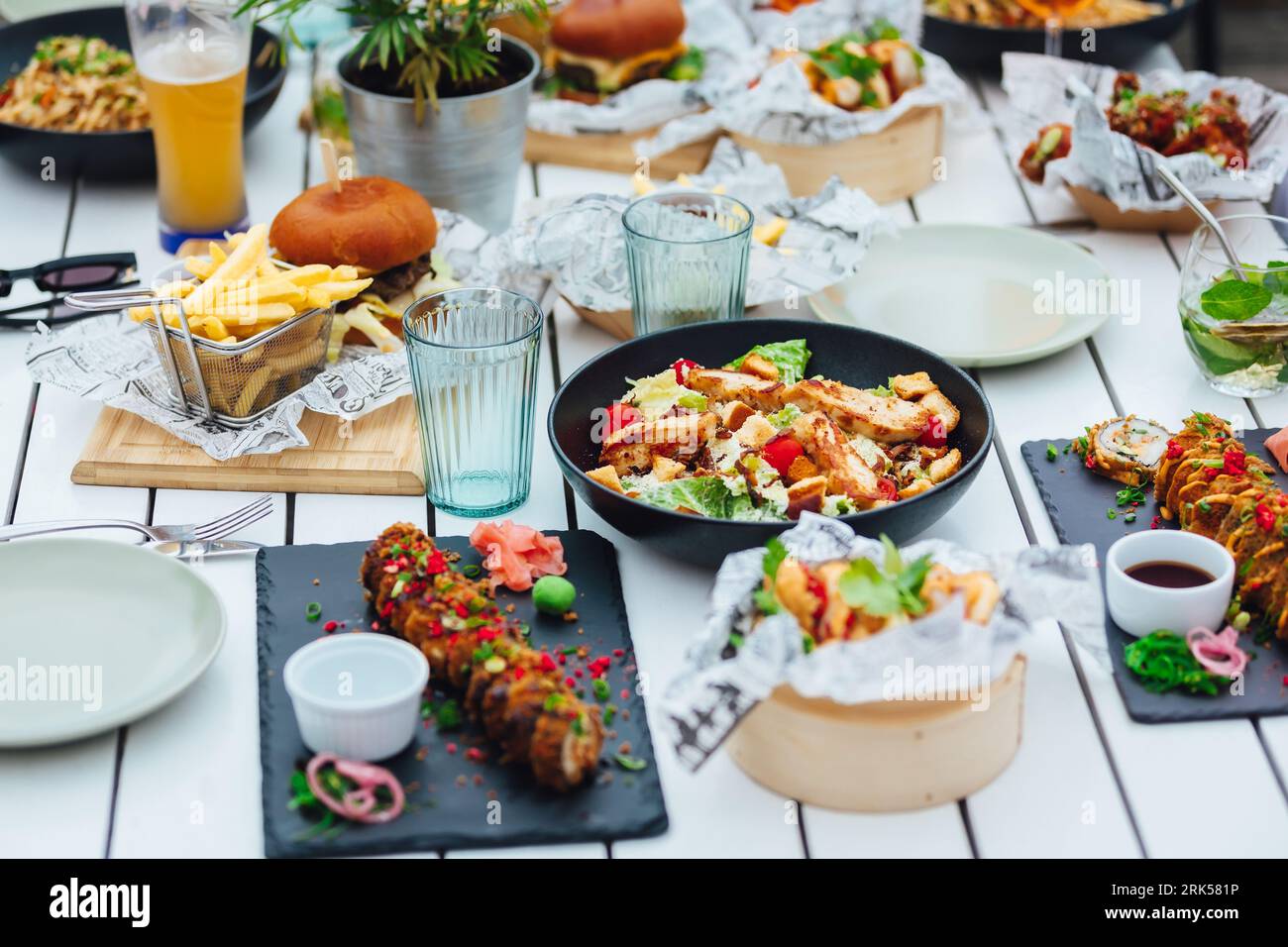 A group of people enjoying a meal together in an outdoor restaurant in ...