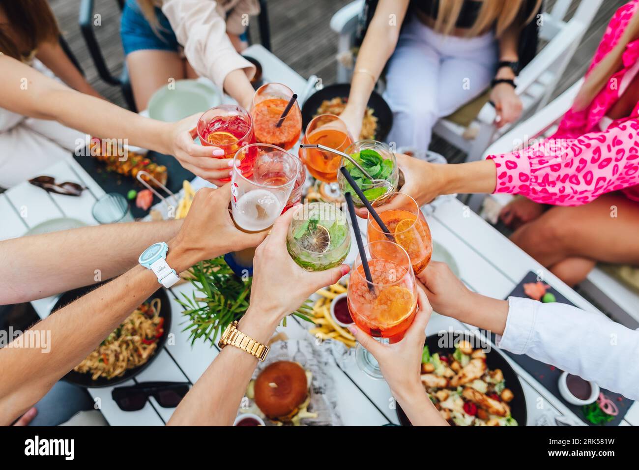 A group of friends drinking tasty cocktails in an outdoor setting in ...