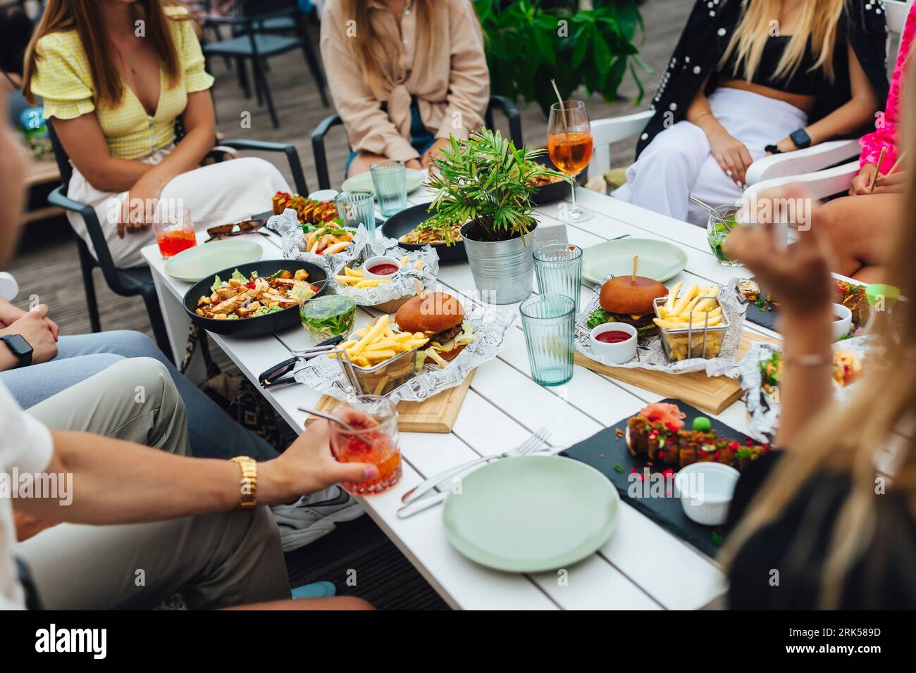 A group of people enjoying a meal together in an outdoor restaurant in ...
