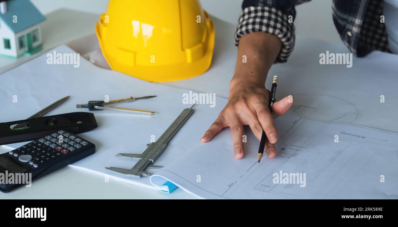 Closeup hand of engineer with construction work plan discussion ...