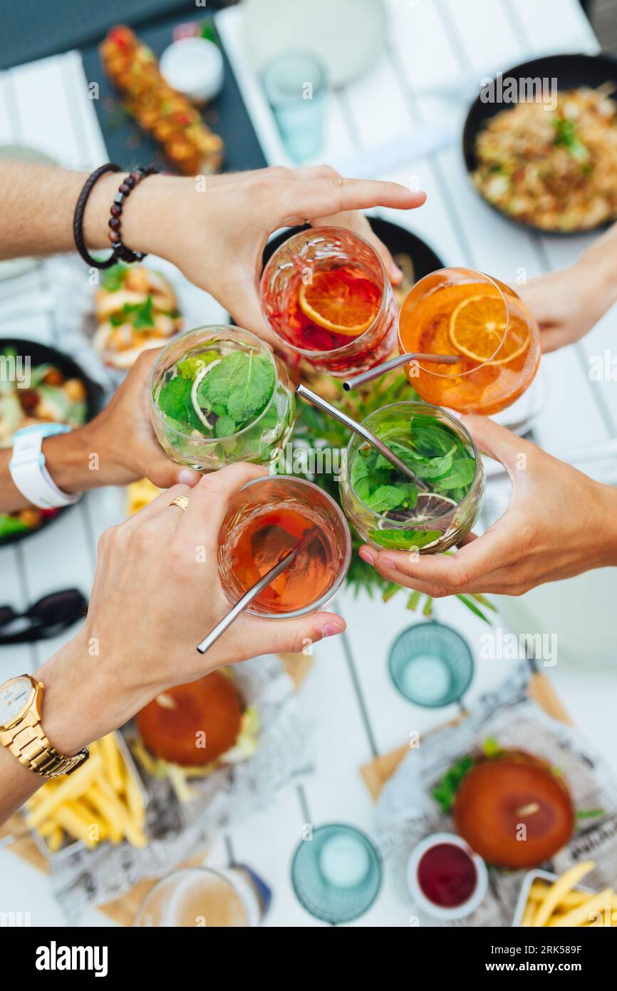 A group of friends drinking tasty cocktails in an outdoor setting in ...