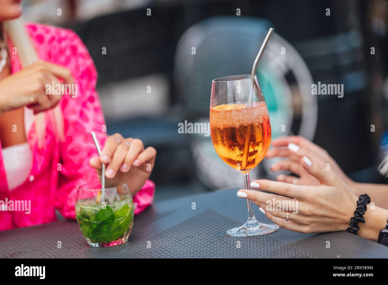 A group of friends drinking tasty cocktails in an outdoor setting in ...