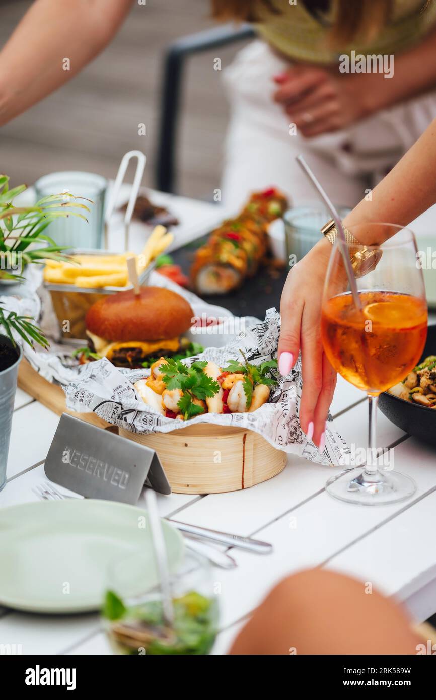 A group of people enjoying a meal together in an outdoor restaurant in ...