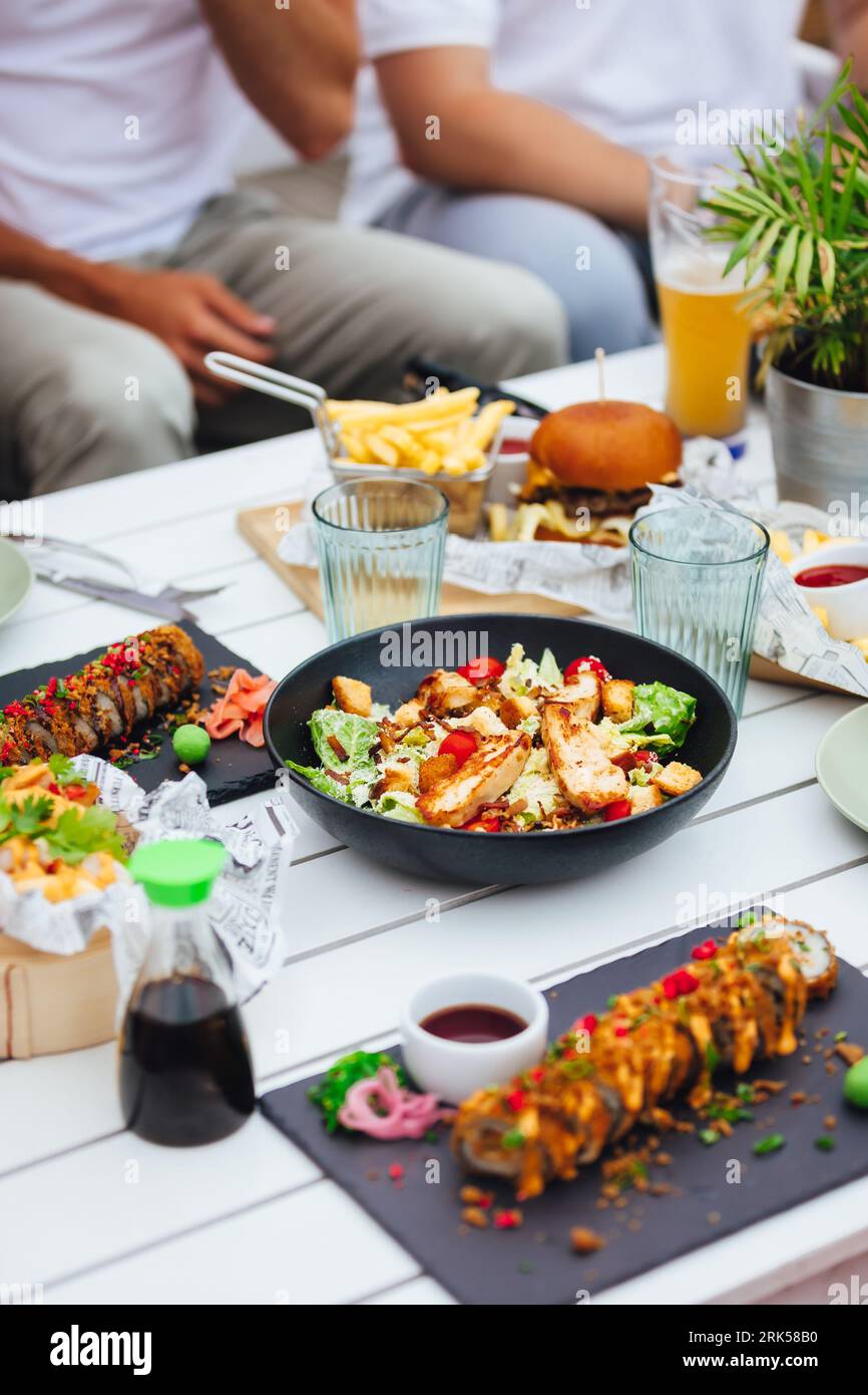 A group of people enjoying a meal together in an outdoor restaurant in ...