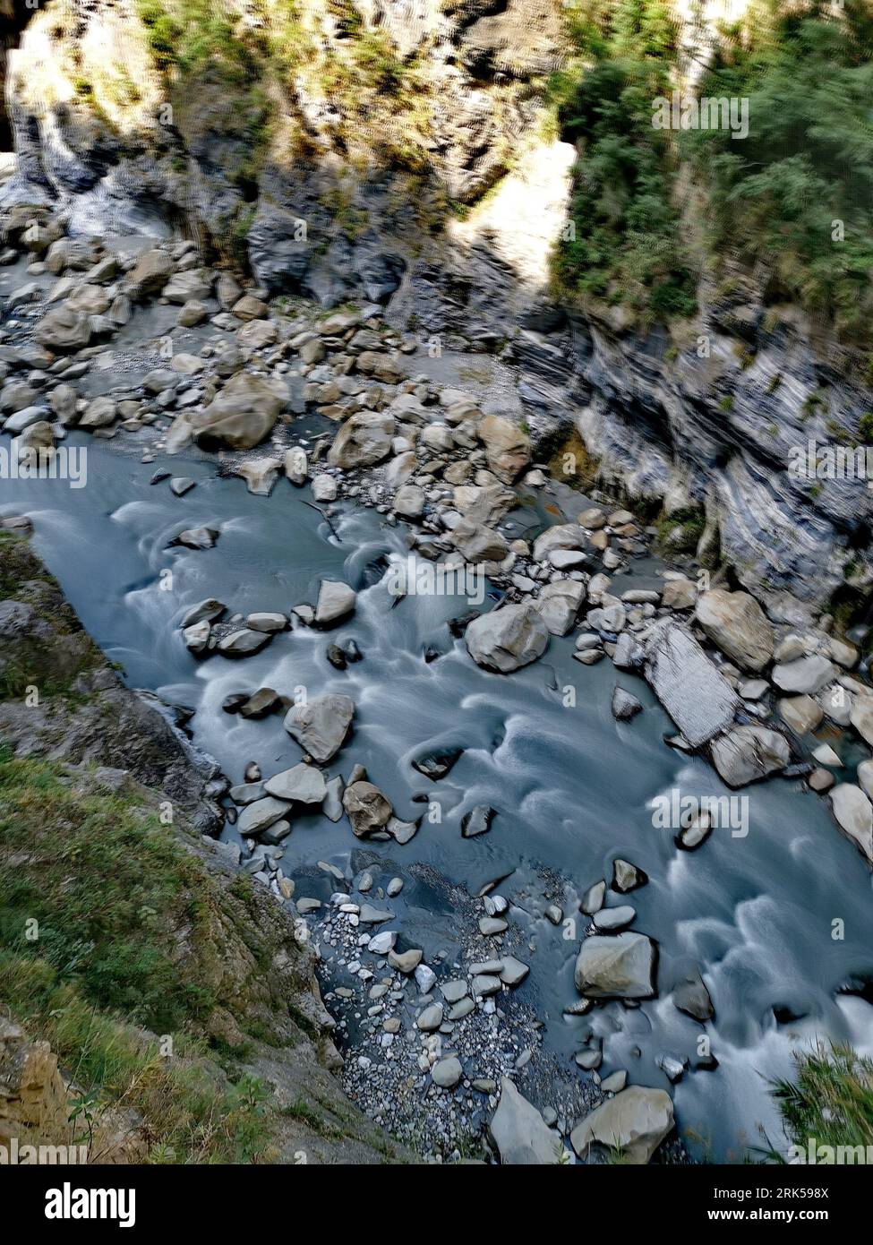 A high angle view of a river running across a rocky ground in Taroko ...