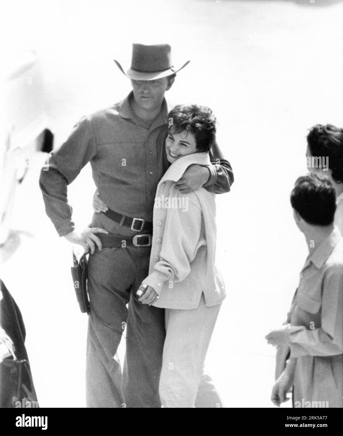 ROBERT MITCHUM on set location candid with Set Visitor JEAN SIMMONS ...