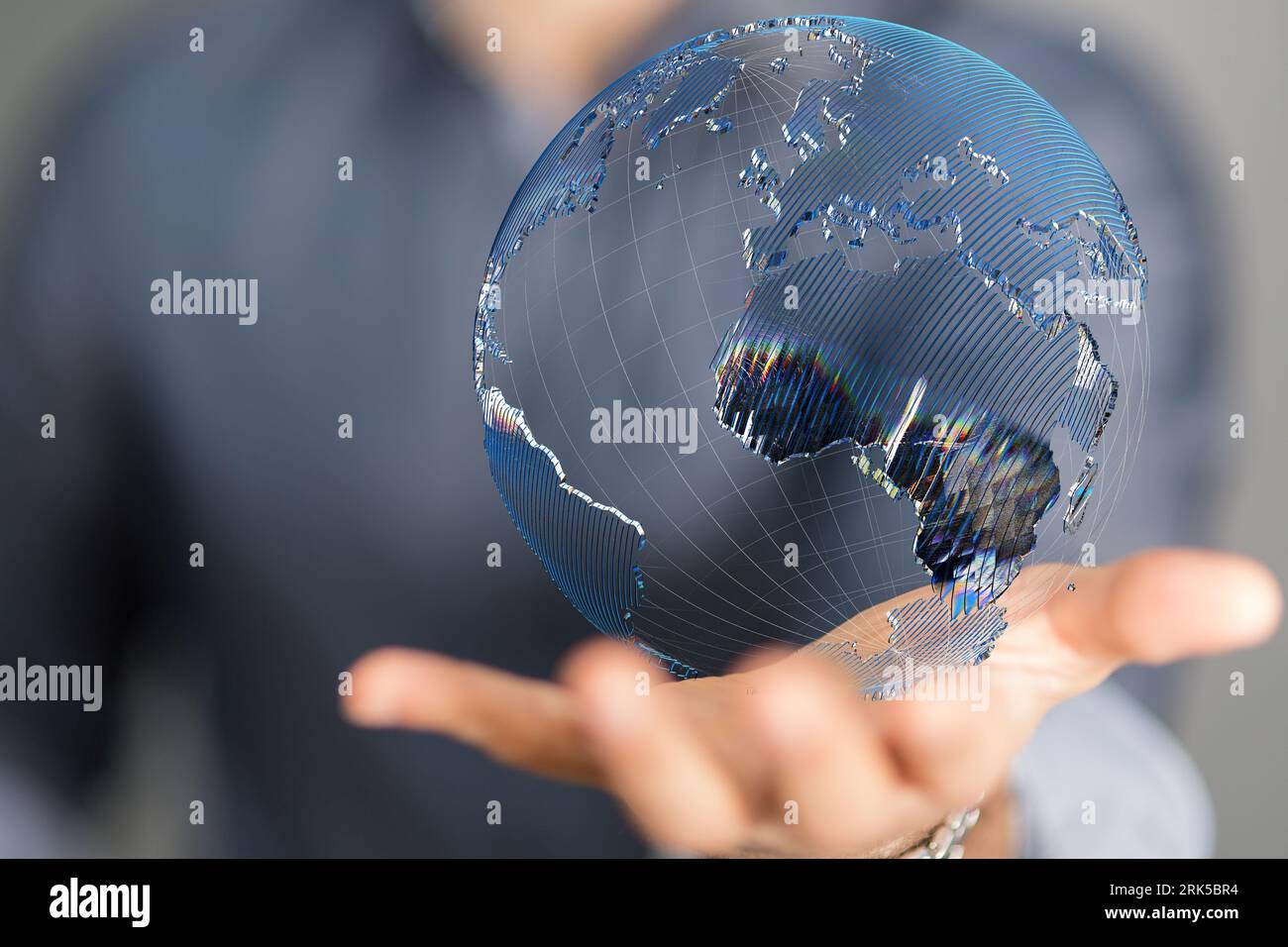A person standing in front of a large 3D model of the Earth, gesturing ...