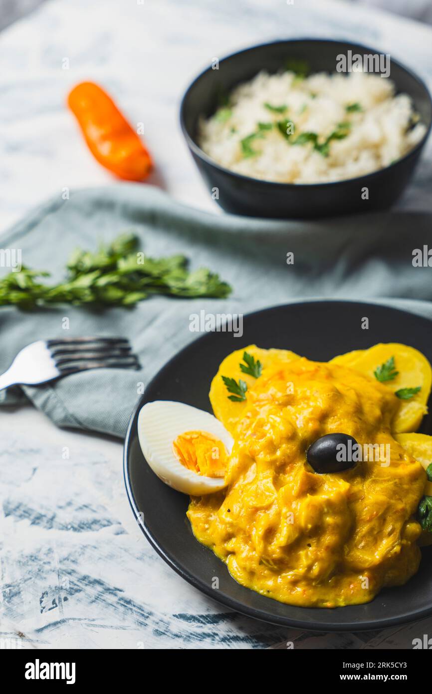 A plate of traditional Peruvian aji de gallina made with chicken and ...
