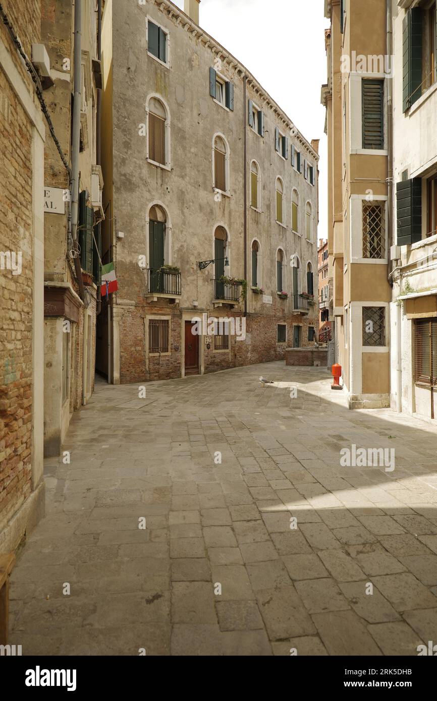 A bustling Italian cityscape with narrow, cobblestone streets lined ...