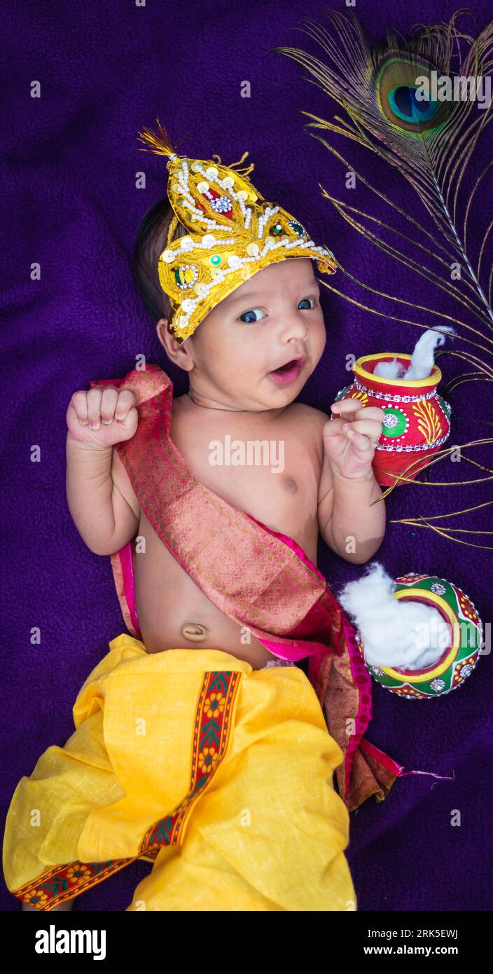 newborn baby boy in krishna dressed with props from unique perspective ...