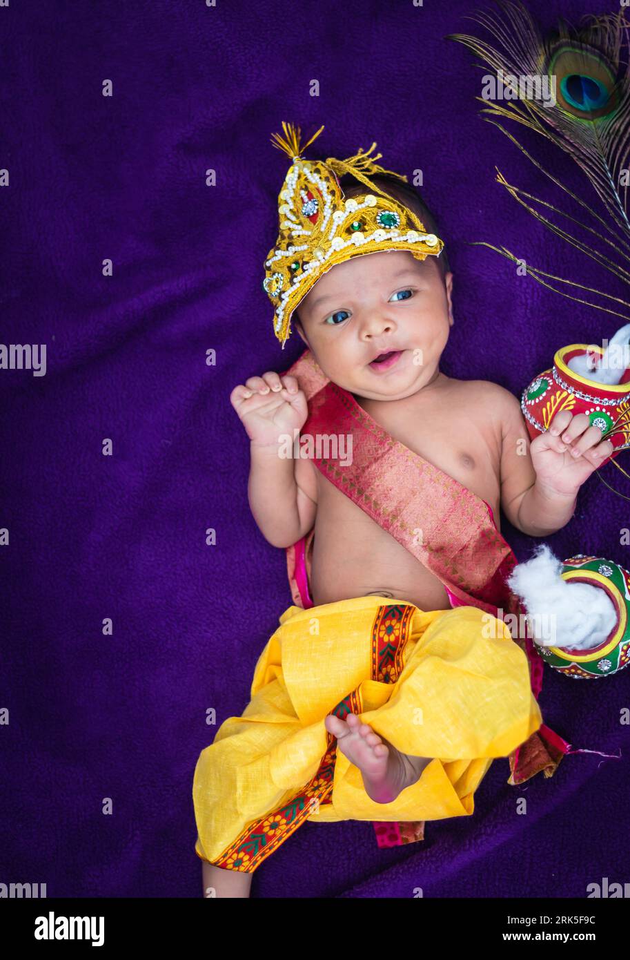 newborn baby boy in krishna dressed with props from unique perspective ...
