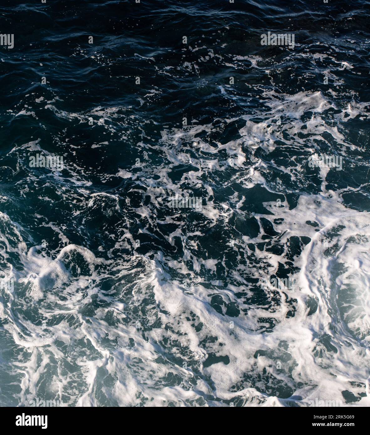 A picturesque ocean landscape featuring a boat in the foreground and ...