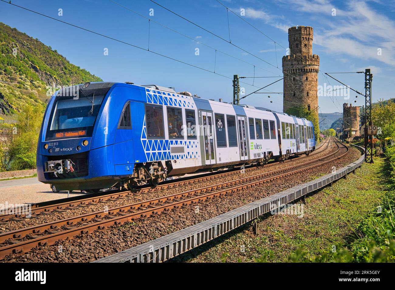 A blue train traveling through scenic German landscape Stock Photo - Alamy