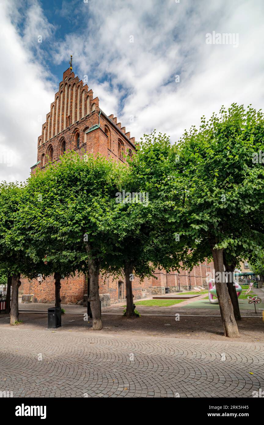 The exterior of St. Mary's Church with green trees in the courtyard ...