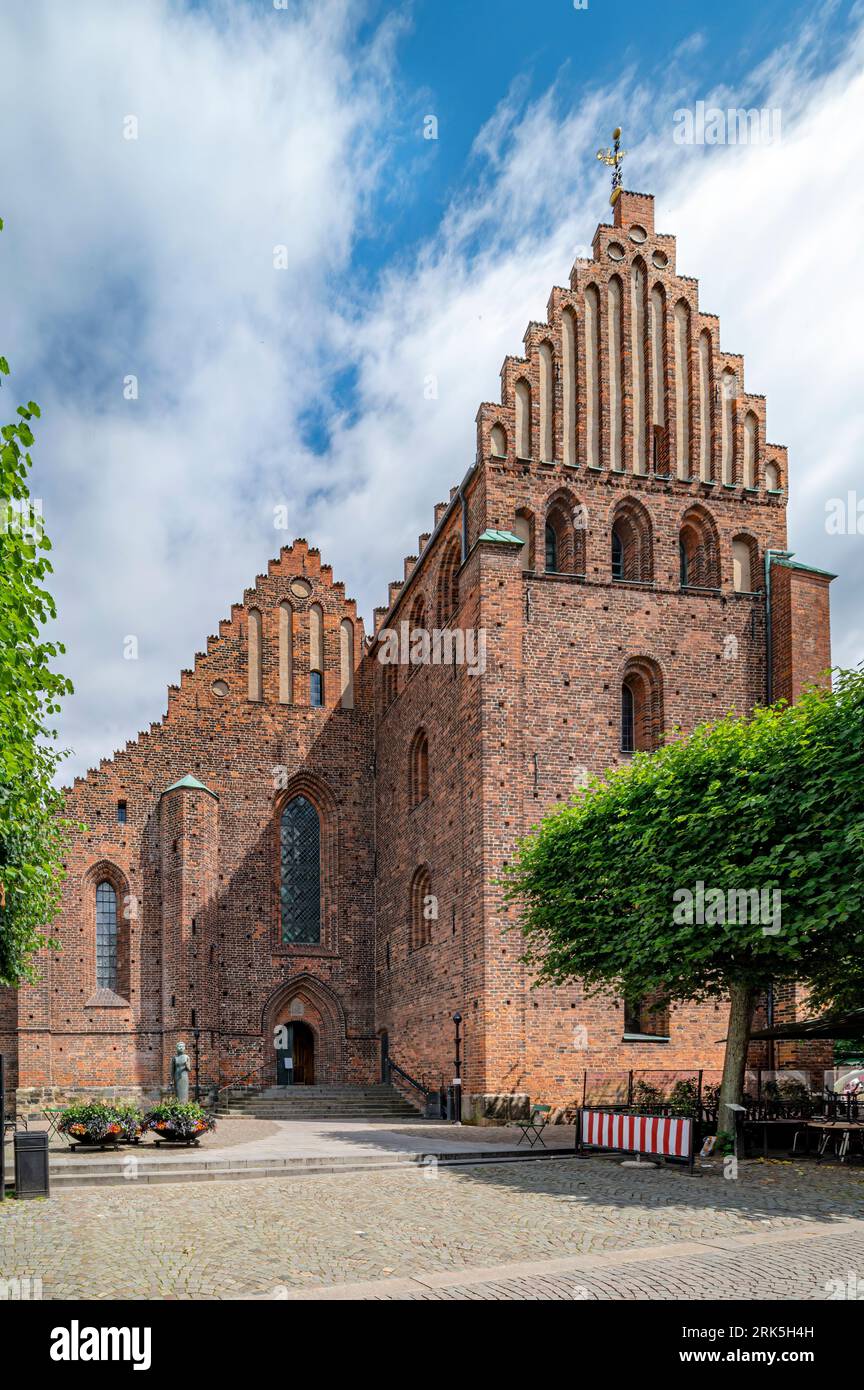 The exterior of St. Mary's Church with green trees in the courtyard ...