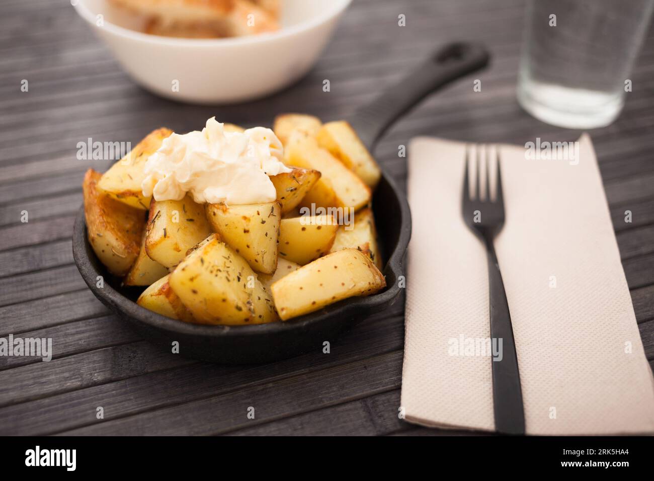 Spanish traditional appetizer patatas bravas with alioli sauce on small ...