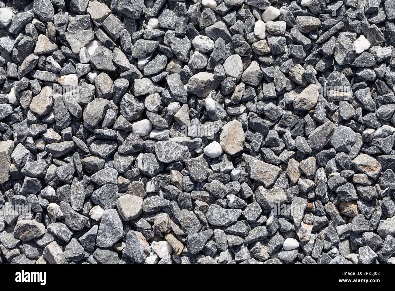 Crushed grey stone on the ground texture background Stock Photo - Alamy