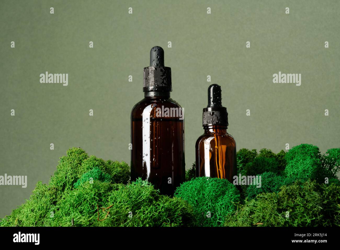 Vape smoking liquid bottles on moss background Stock Photo - Alamy