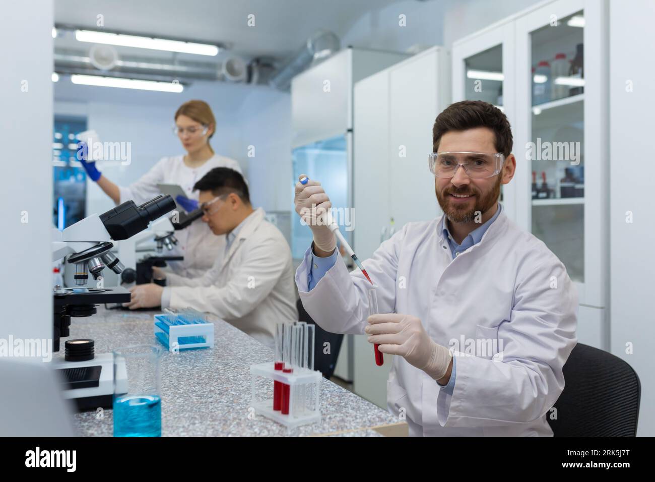 Young male and female students, doctors and scientists study in the ...