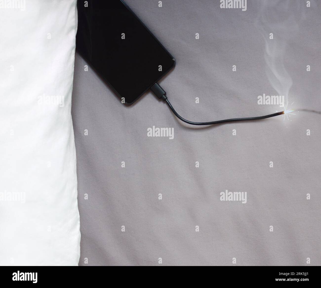 A generic modern phone with a lit fuse as it's charger cord Stock Photo ...