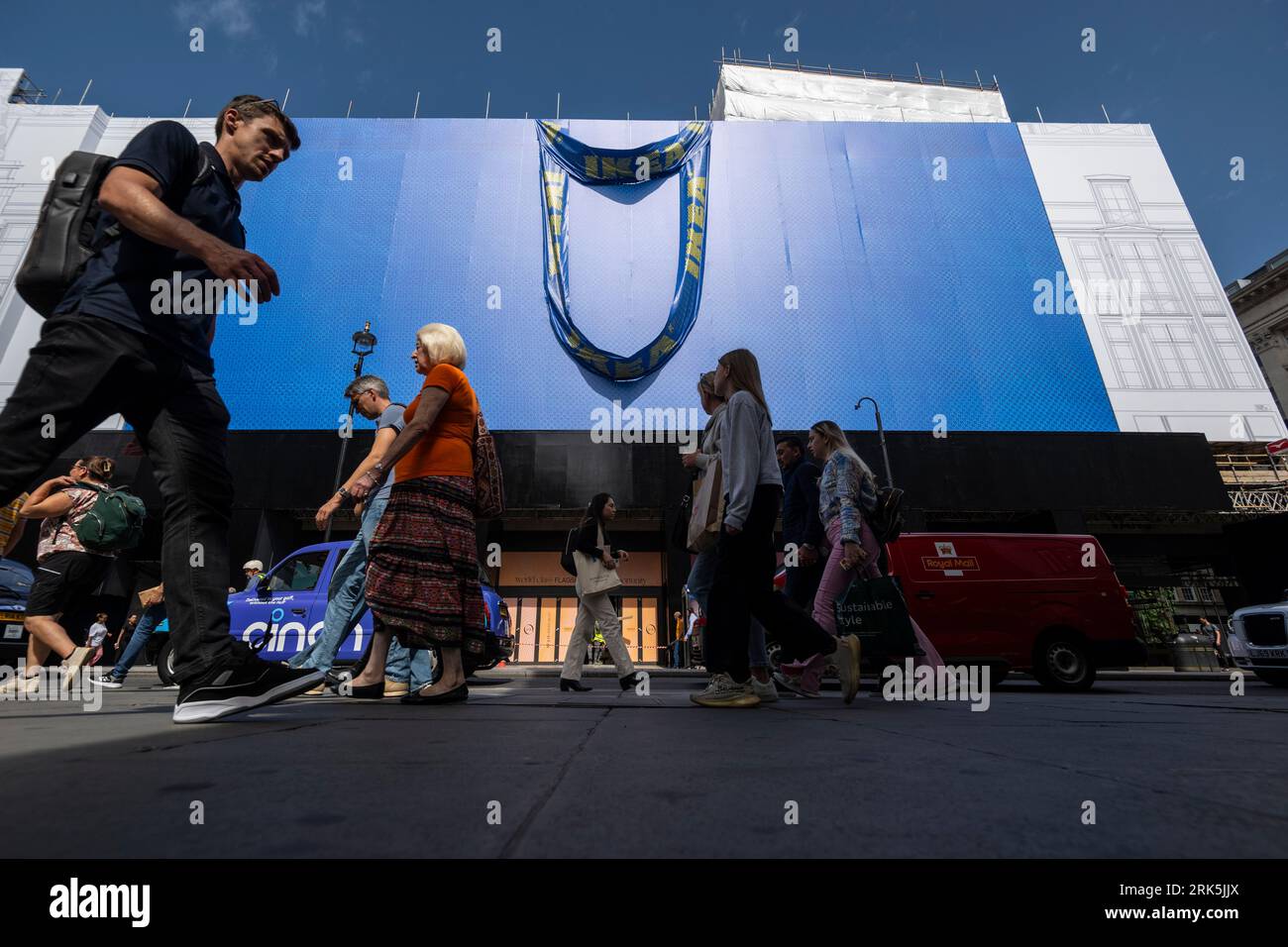 London, UK. 24 August 2023. People pass a giant IKEA shopping bag which ...