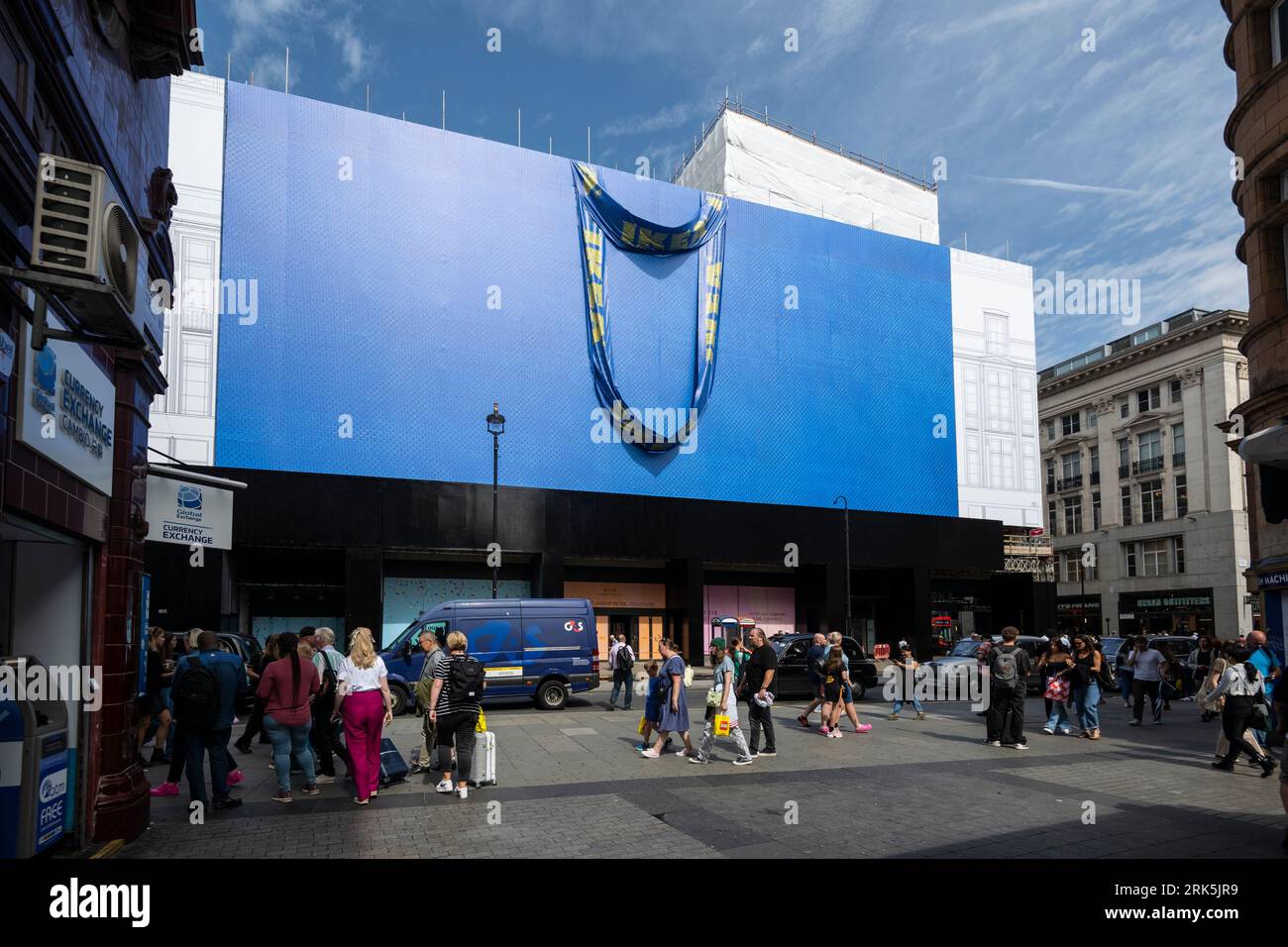 London, UK. 24 August 2023. People pass a giant IKEA shopping bag which ...