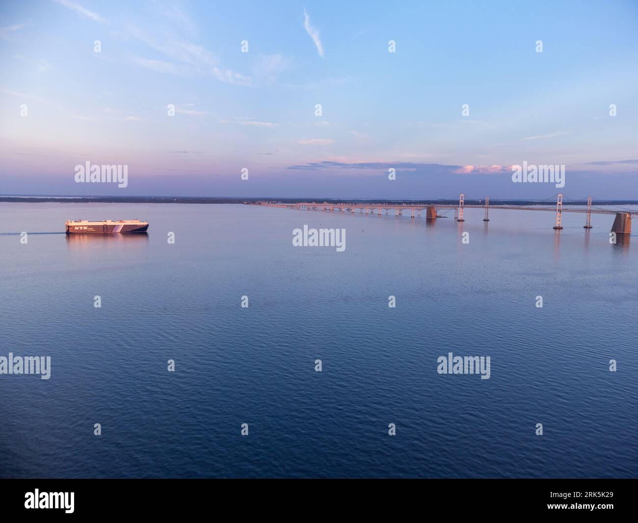 An aerial photo of a Cargo Boat passing under the Chesapeake Bay Bridge ...
