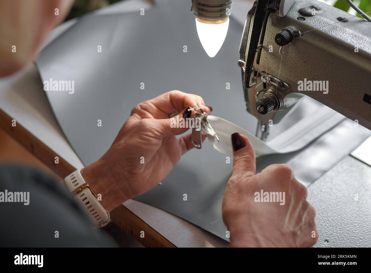 A closeup of the process of sewing on a sewing machine Stock Photo - Alamy