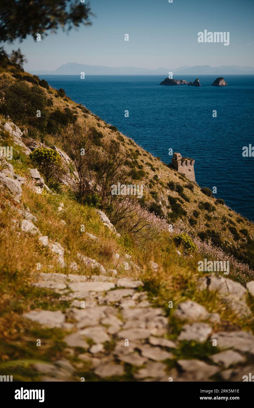 A vertical of an old castle on a hill in South Italy against the sea ...