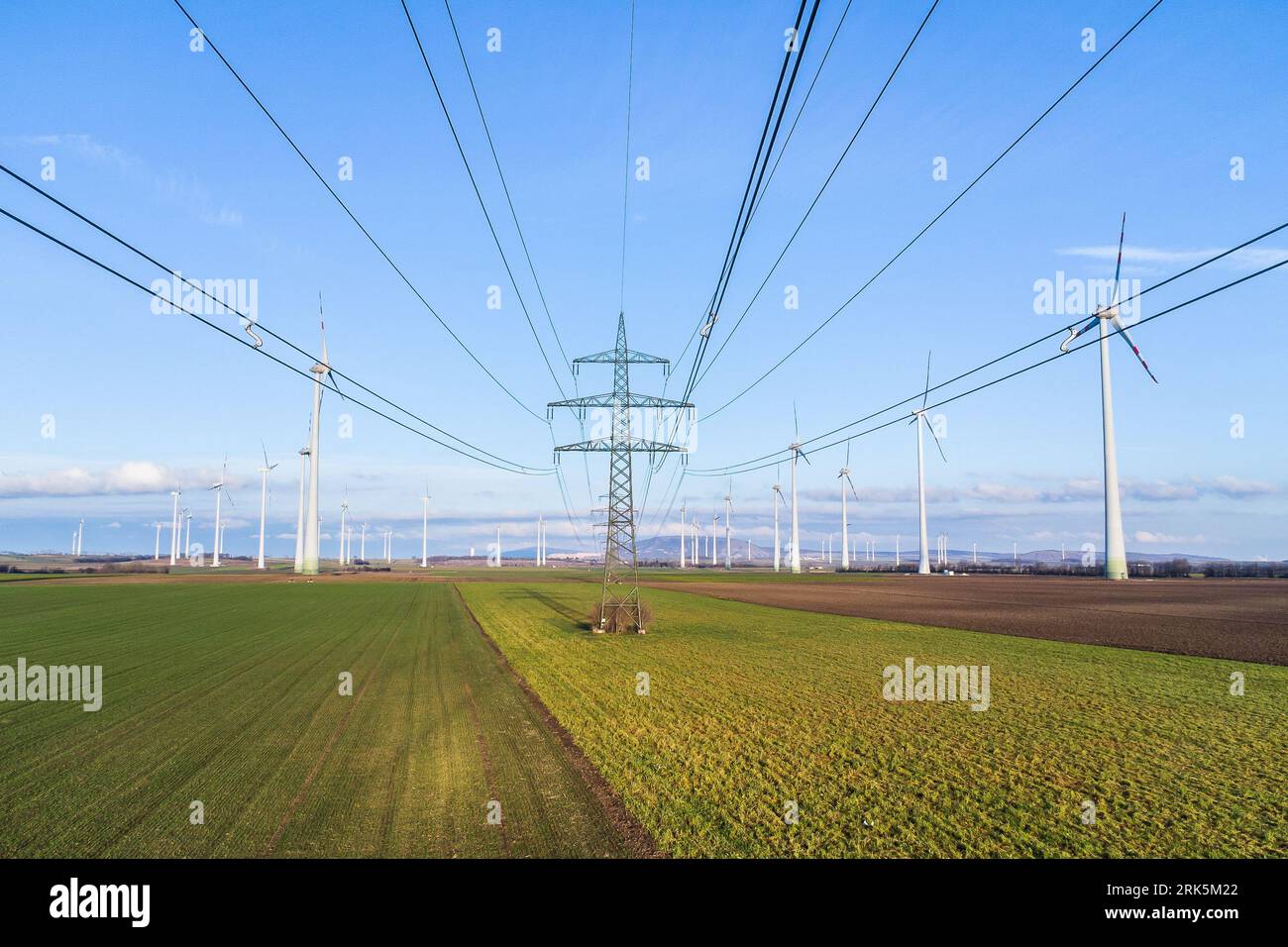 Cables and wires of an electrical power line with windmills for wind ...