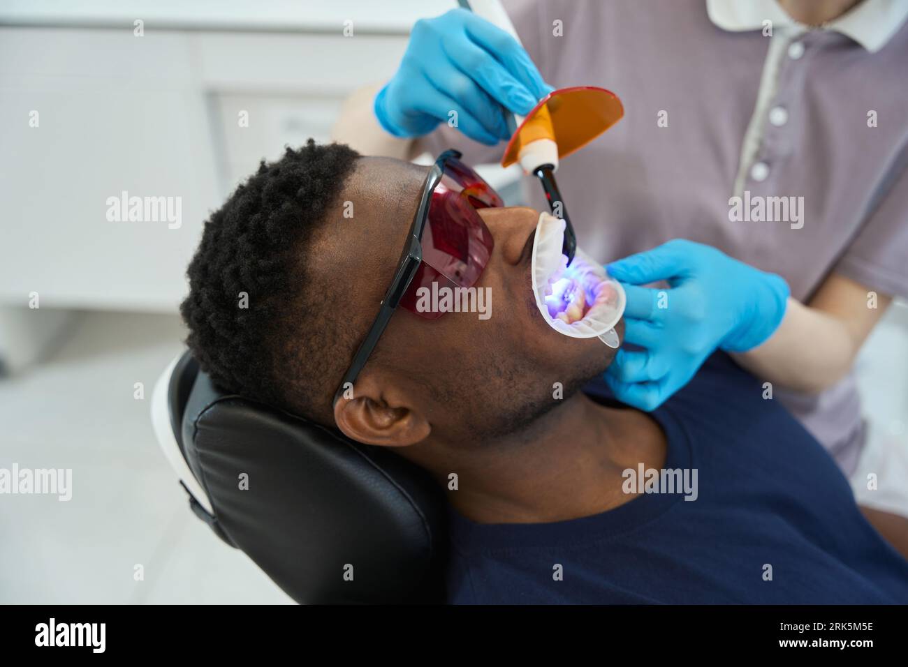 Close up photo of nurse treating patient Stock Photo - Alamy