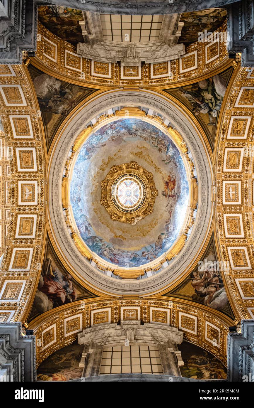 The grandiose domed ceiling of St. Peter's Basilica with intricate ...