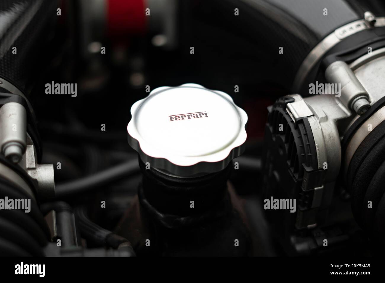 A close up of a vehicle engine with a Ferrari logo emblem visible Stock ...