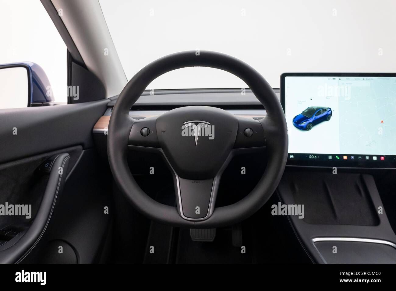 A close-up of an interior Tesla dashboard with a sleek, modern black ...